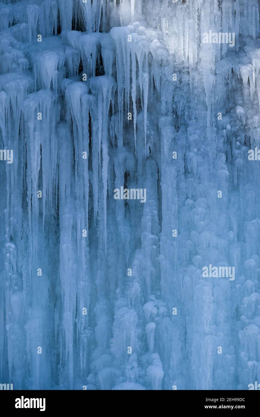 Beautiful ice structures of a frozen waterfall, pretty icicles forming ...