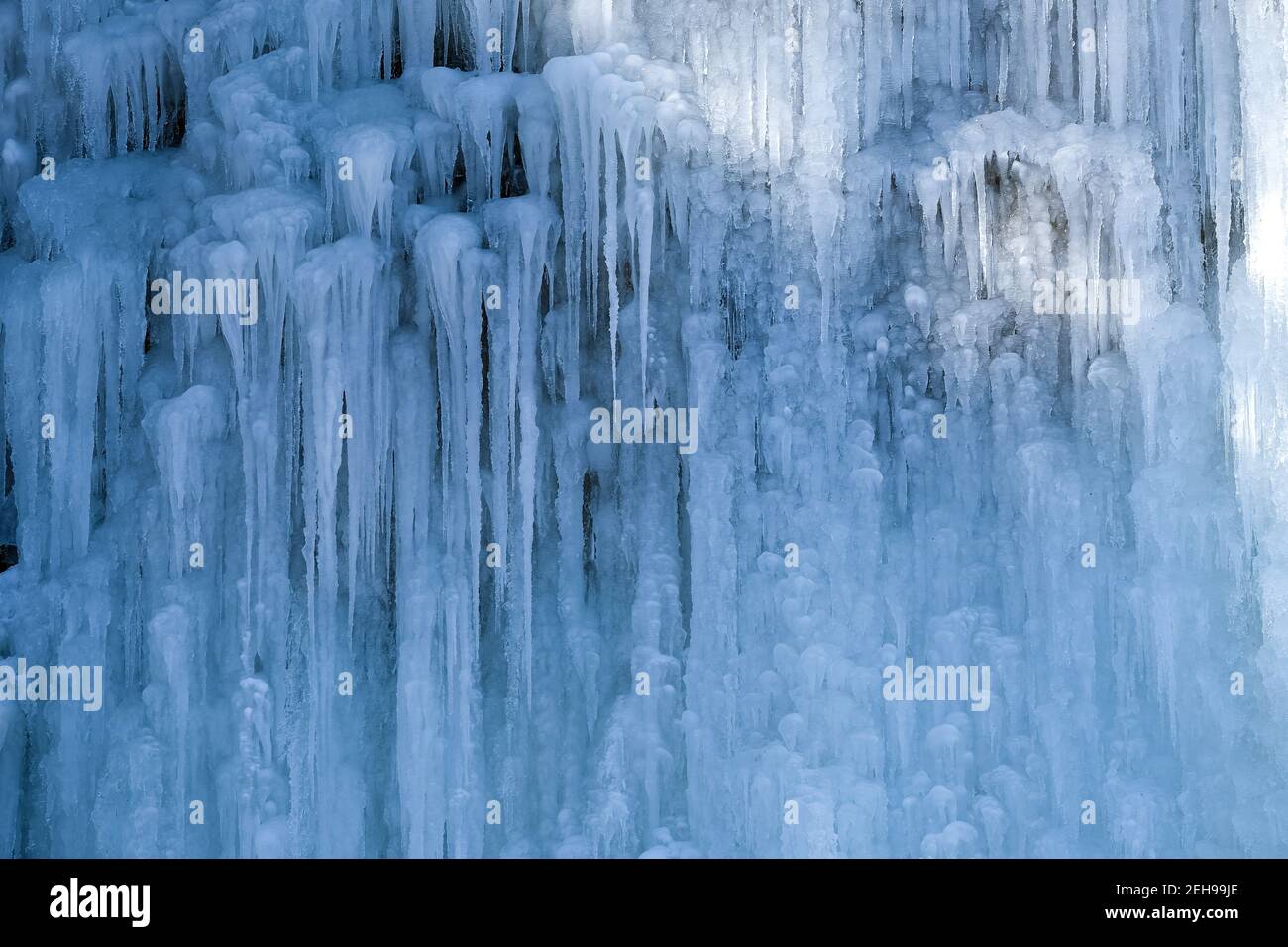 Beautiful ice structures of a frozen waterfall, pretty icicles forming ...