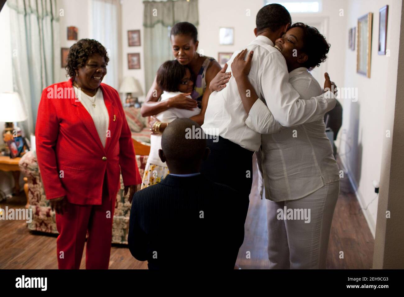 President Barack Obama and First Lady Michelle Obama greet members of ...