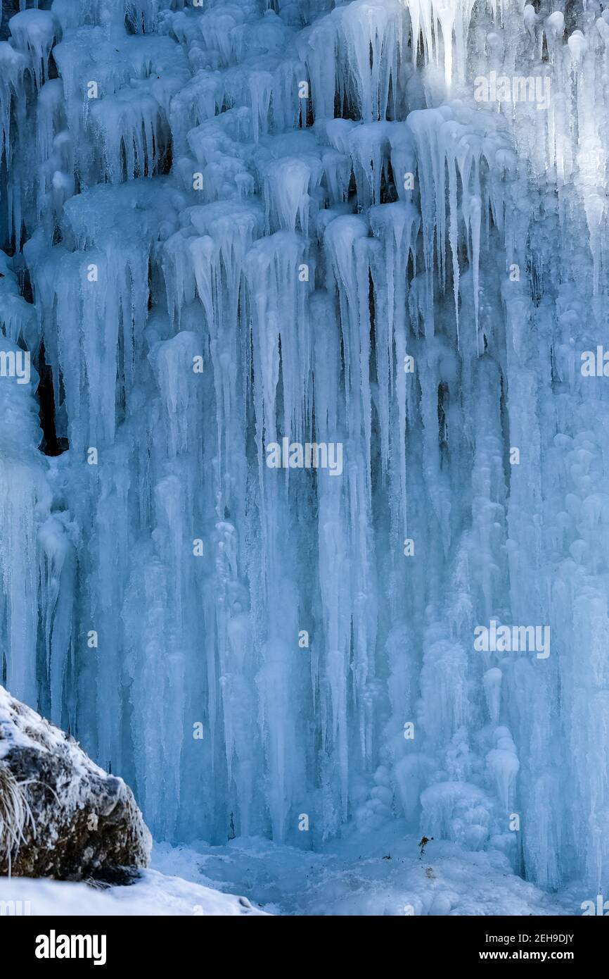 Beautiful ice structures of a frozen waterfall, pretty icicles forming ...