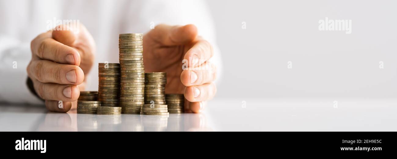 Save Business Money. Employee Protecting Budget Pile Stock Photo - Alamy