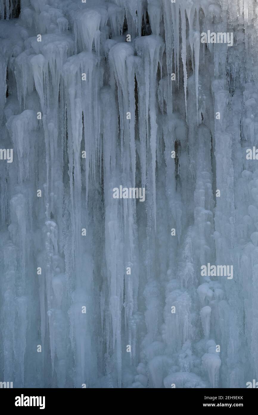 Beautiful ice structures of a frozen waterfall, pretty icicles forming ...