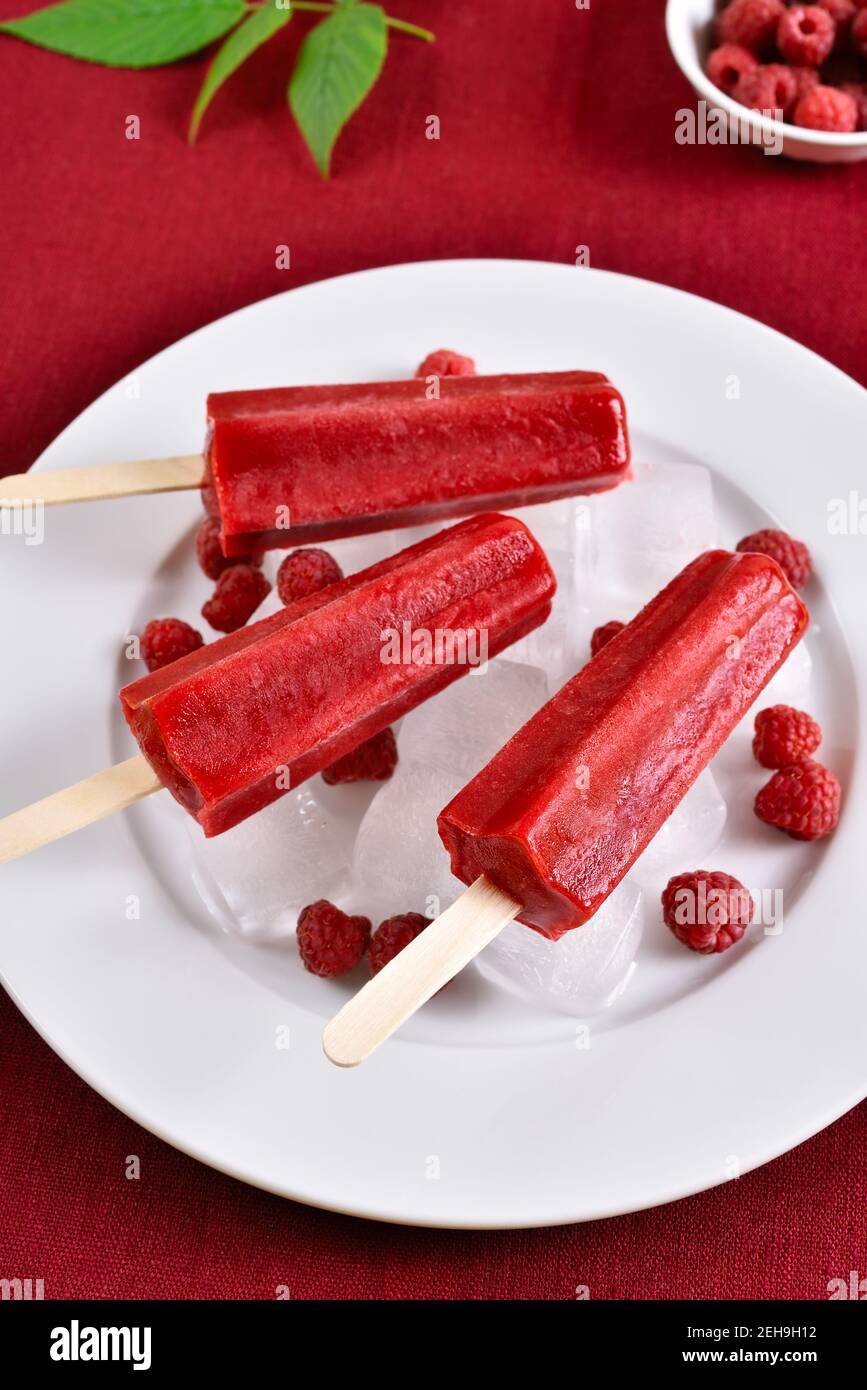 Raspberry ice cream popsicles on white plate. Tasty summer dessert ...