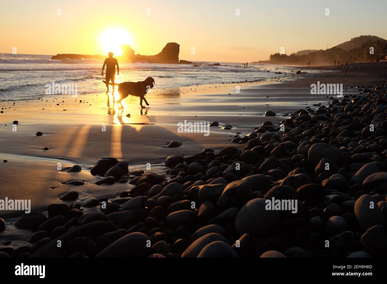 El Salvador El Tunco Silhouette of a man, his dog, and the large pig ...