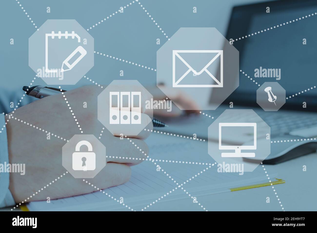 Person working on a laptop and taking notes with digital icons ...