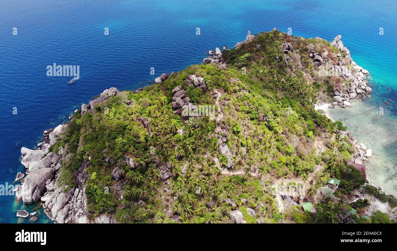 Calm colorful azure turquoise sea near tiny tropical volcanic island ...