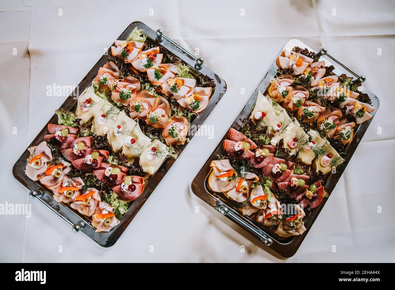 two cold meat slices plates on a dinner table Stock Photo - Alamy