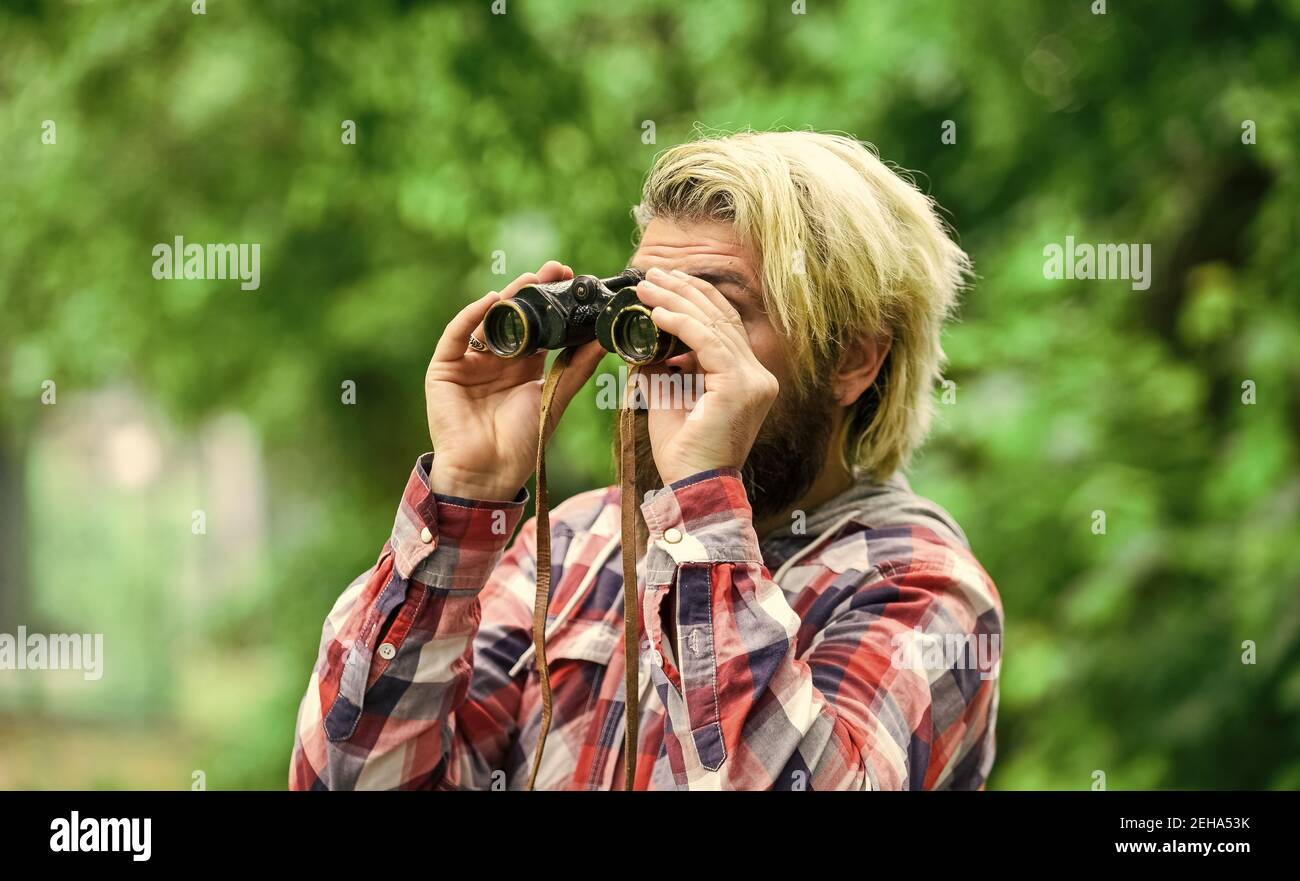 traveling around the world. bearded man look through binoculars ...
