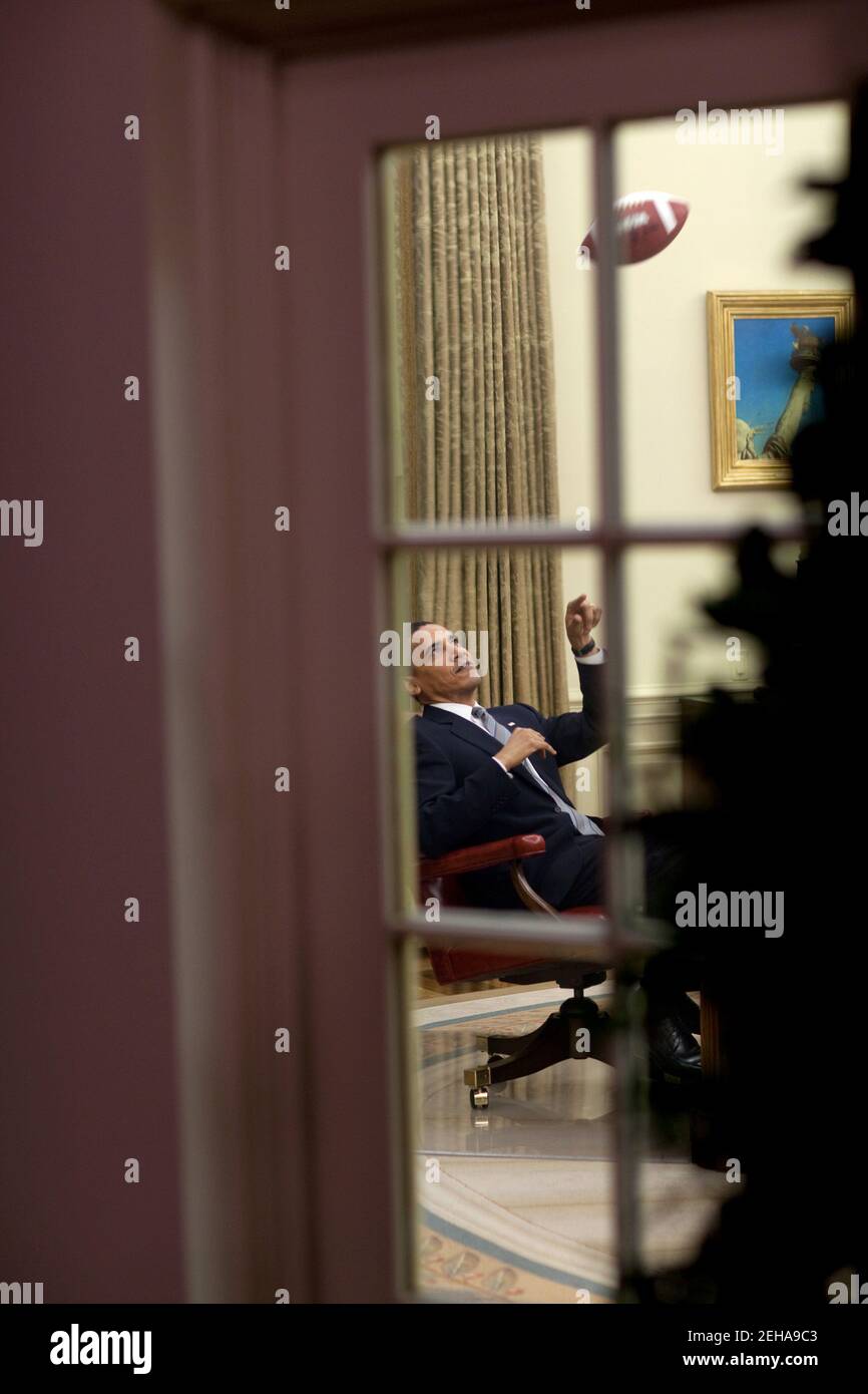 President Barack Obama plays with a football in the Oval Office 4/23/09 ...