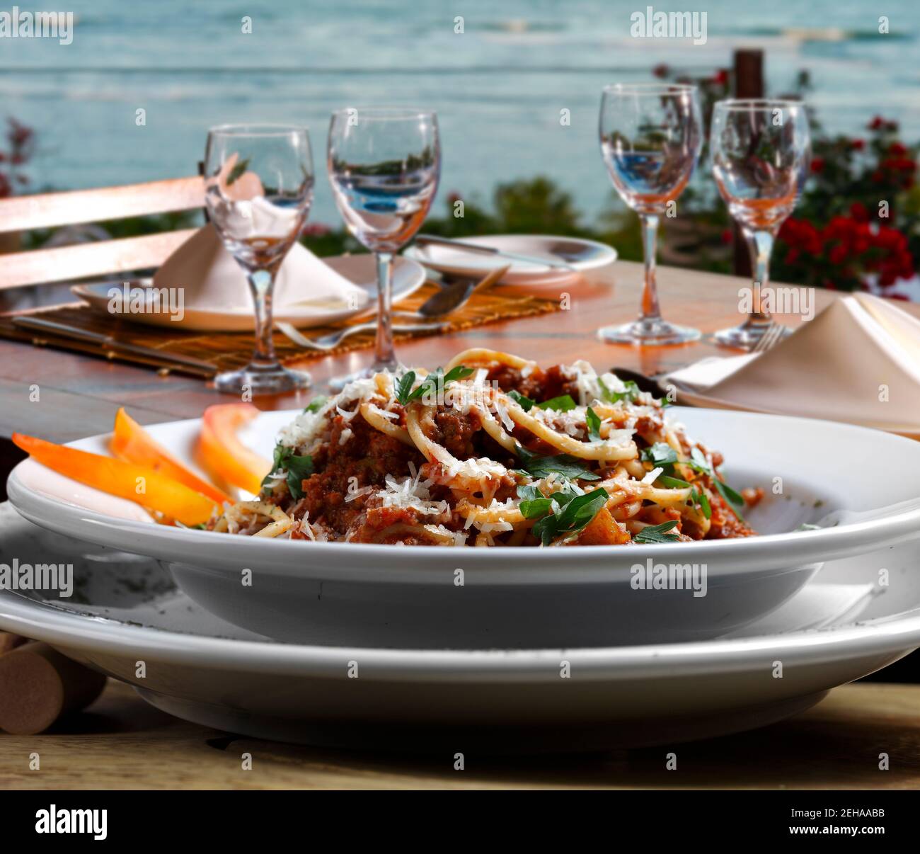 Spaghetti with bolognese sauce restaurant on the beach Stock Photo - Alamy
