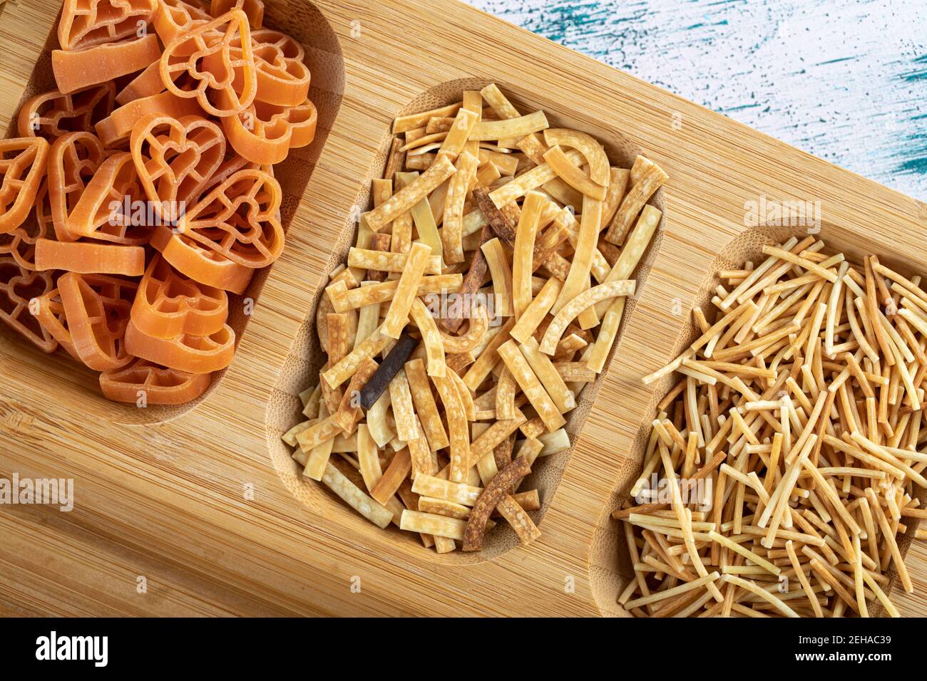 Three types of dry pasta placed on wooden plate Stock Photo - Alamy