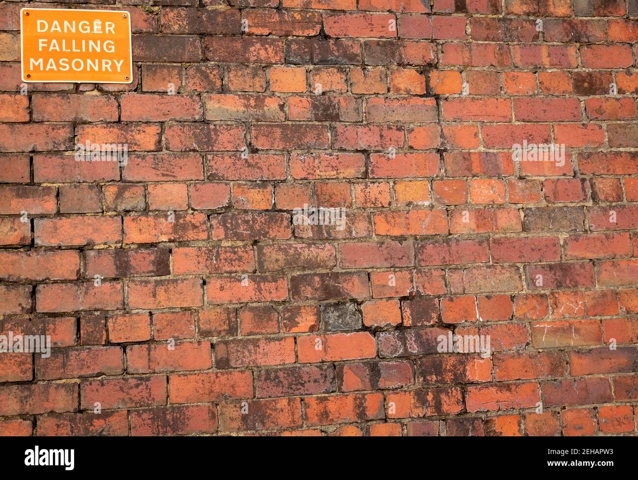 Danger Falling Masonry sign on a old red brick building Stock Photo - Alamy