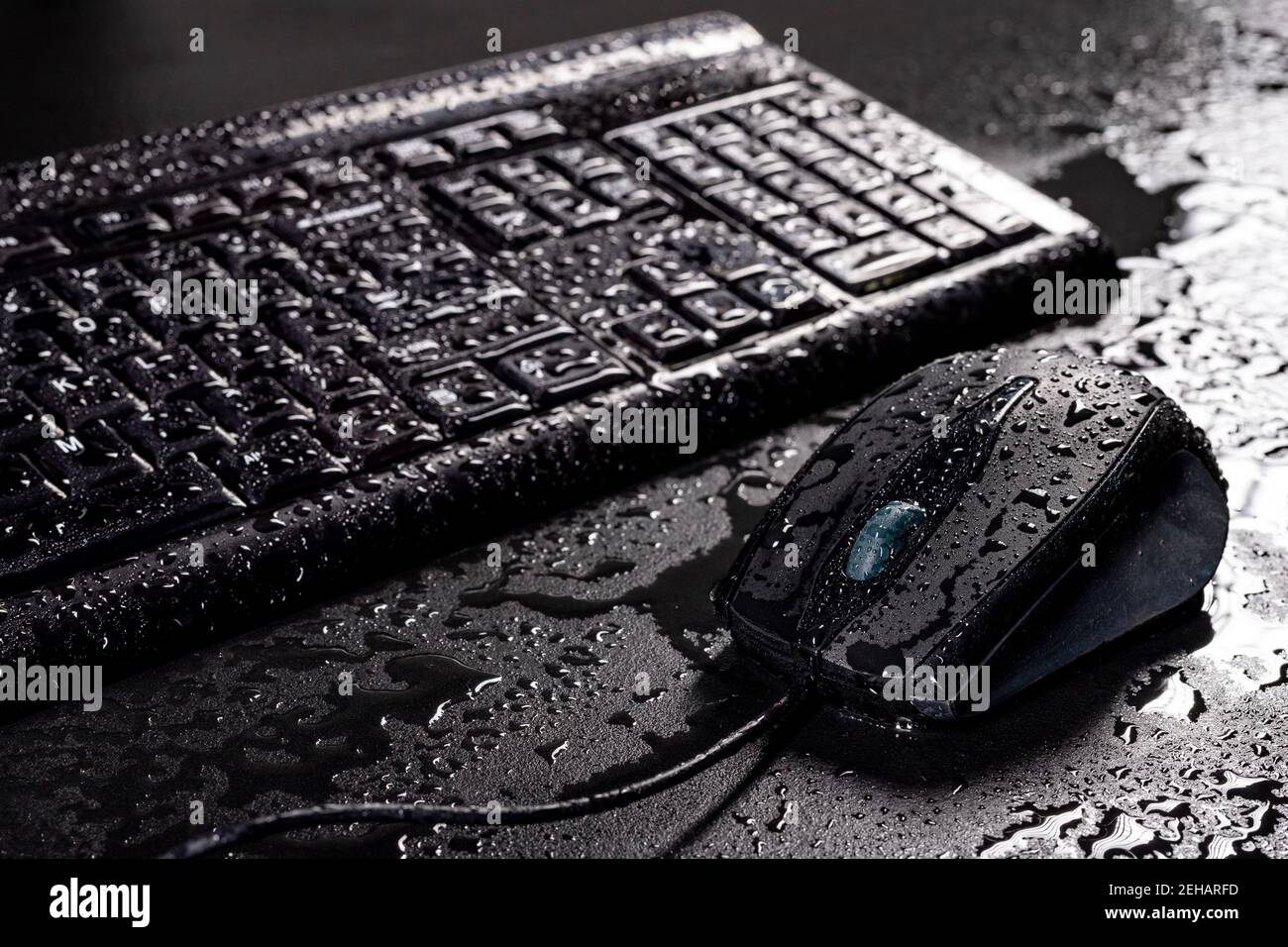 Wet keyboard and mouse from the personal computer. Water drops on an ...