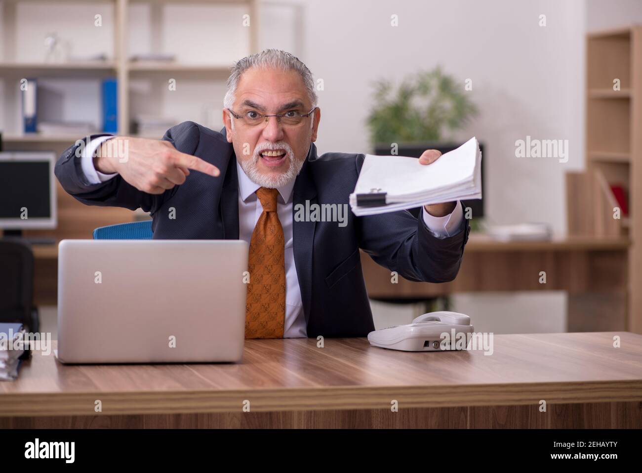 Old employee working in the office Stock Photo - Alamy