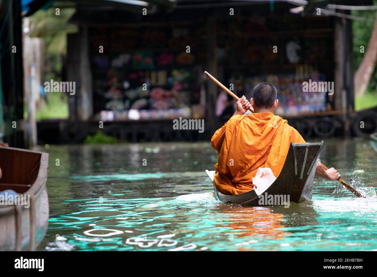 On the floating market: a buddhist monk is using his small boat to ...