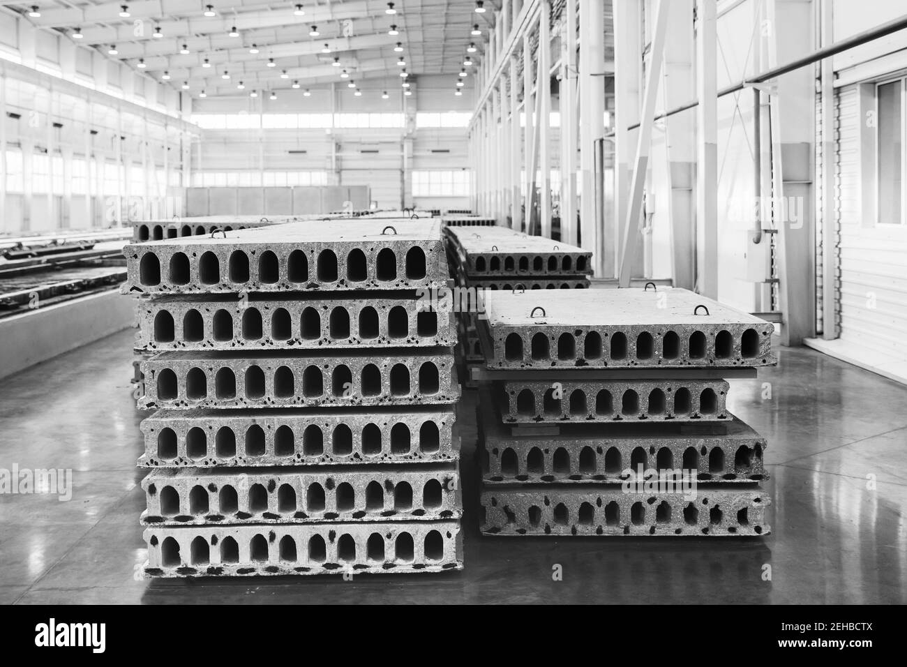 Stack of precast reinforced concrete slabs in a house-building factory ...