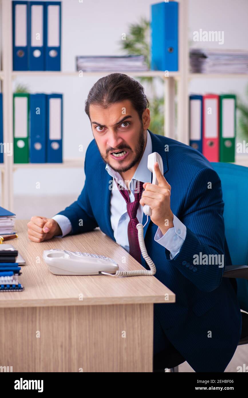 Young employee and too many work in the office Stock Photo - Alamy