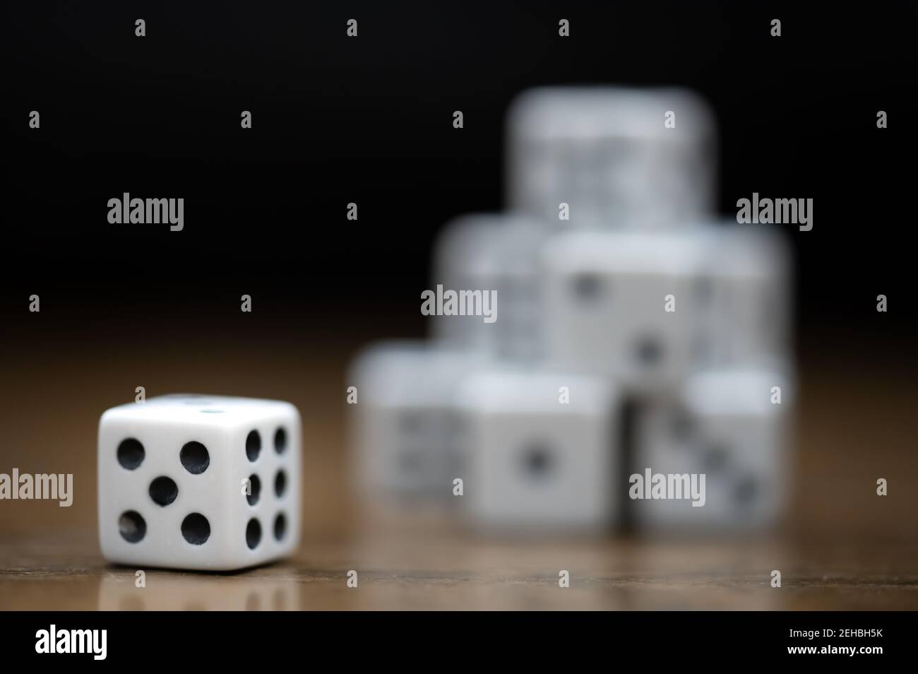 Dice showing a five and a six with a stack of dice in background on a ...