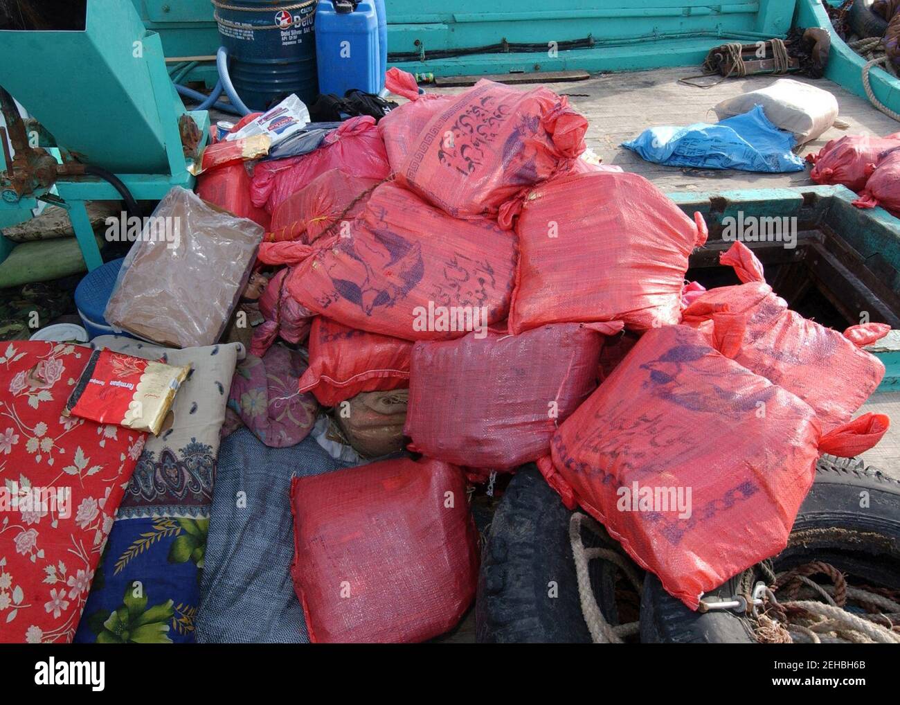 Over 50 bags of hashish are piled on the deck of Decatur (DDG 73) on ...