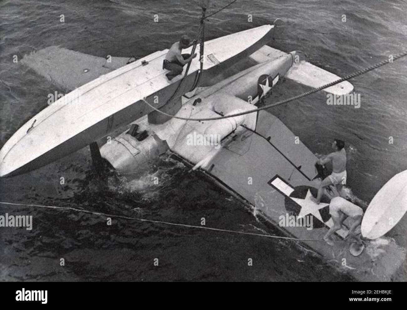 Overturned Curtiss SC-1 Seahawk alongside of USS Topeka (CL-67), in ...