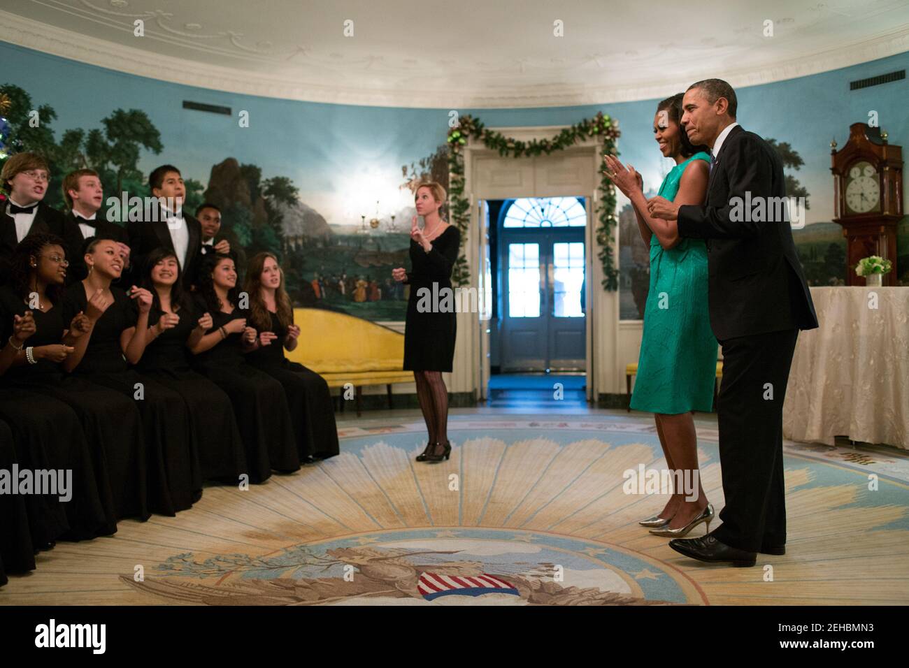 President Barack Obama and First Lady Michelle Obama listen to the ...