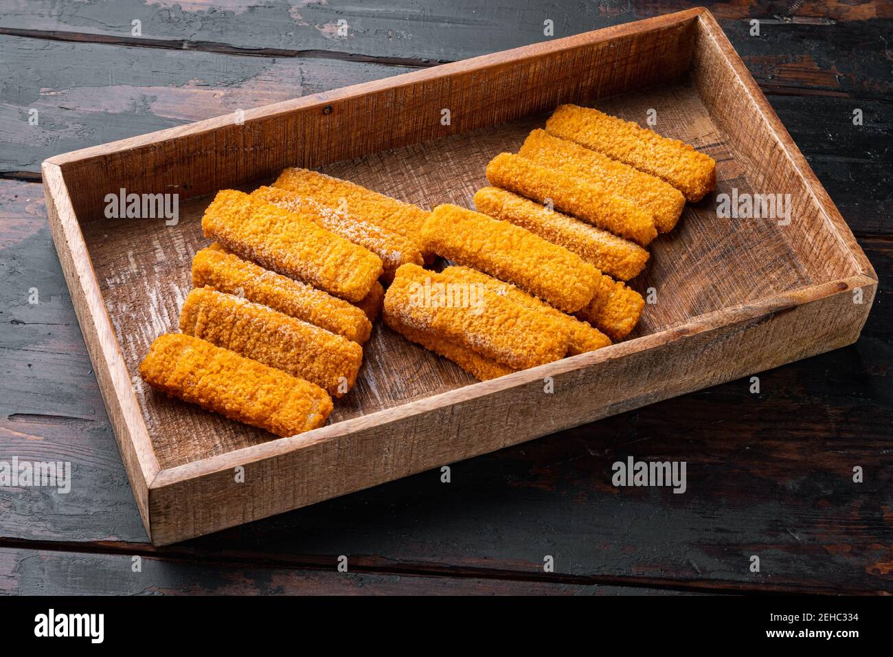 Frozen fish sticks. Organic fish food set, in wooden box, on old dark ...