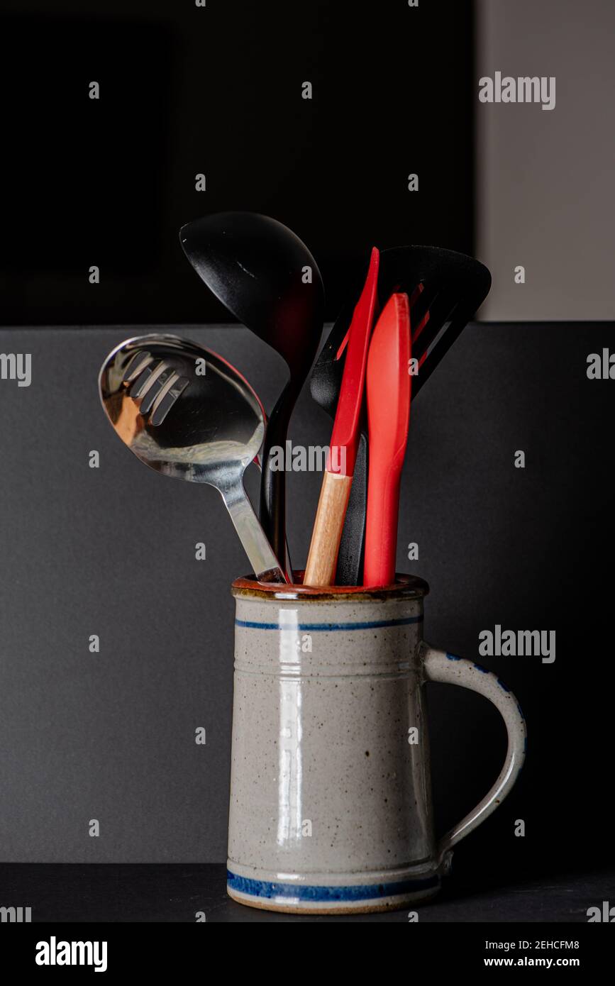 A vertical photo of kitchen utensils framed by shadow and light Stock ...