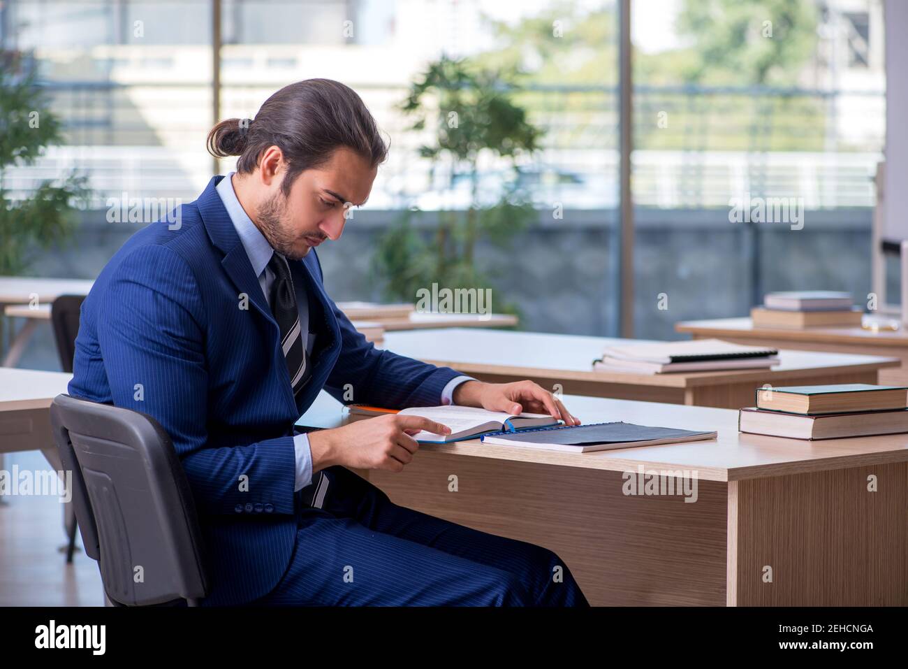 Young teacher in suit in the classroom Stock Photo - Alamy