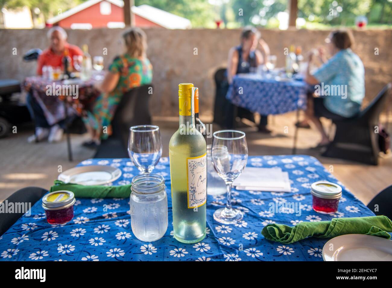 Nicely set table with wine and freshly made jams for farm to table ...