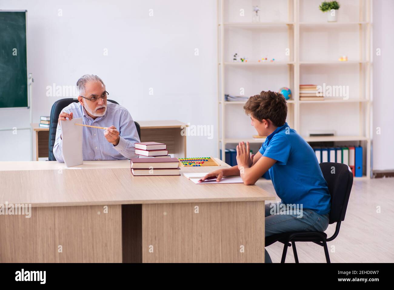 Old teacher and schoolboy in the classroom Stock Photo - Alamy