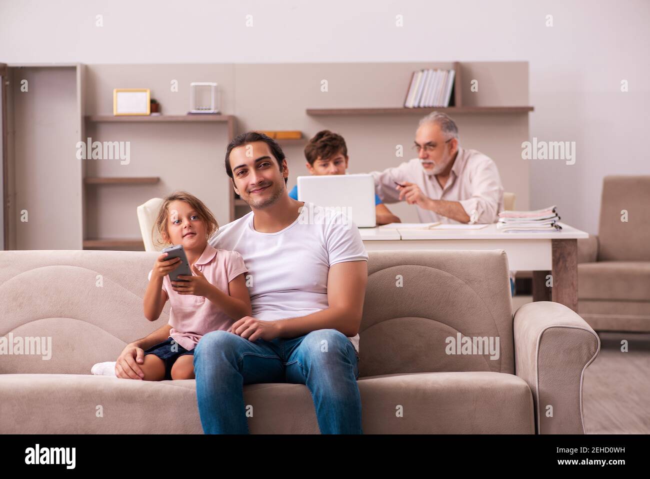Three generations at home in early development concept Stock Photo - Alamy