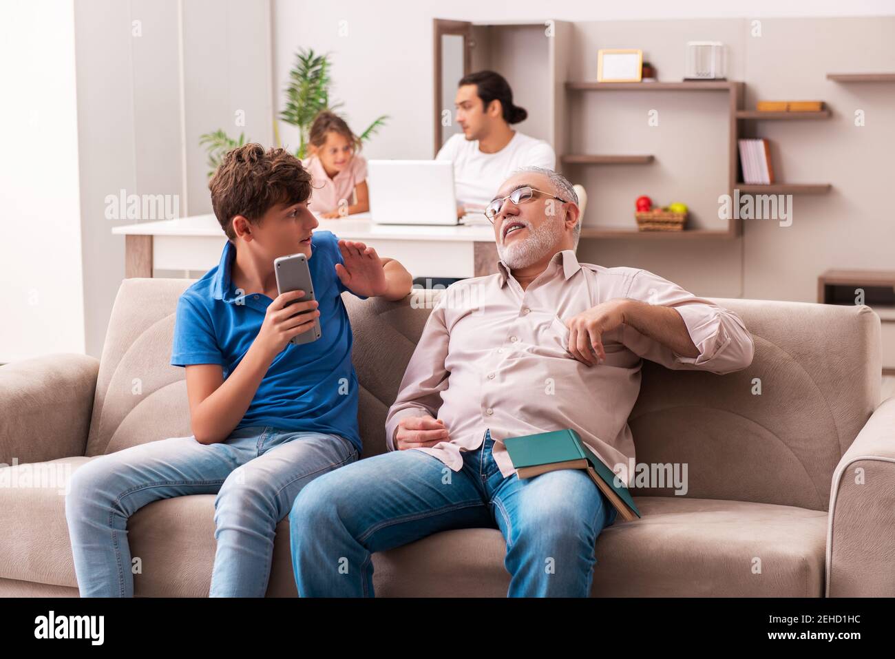 Three generations at home in early development concept Stock Photo - Alamy