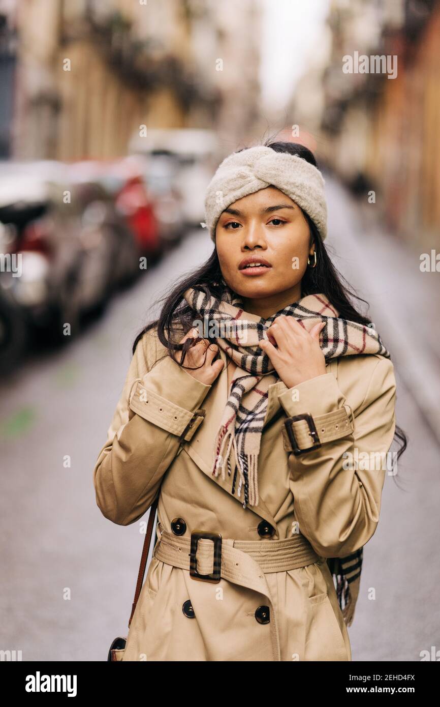 Portrait of an Asian Woman with a brown turban posing in the street ...