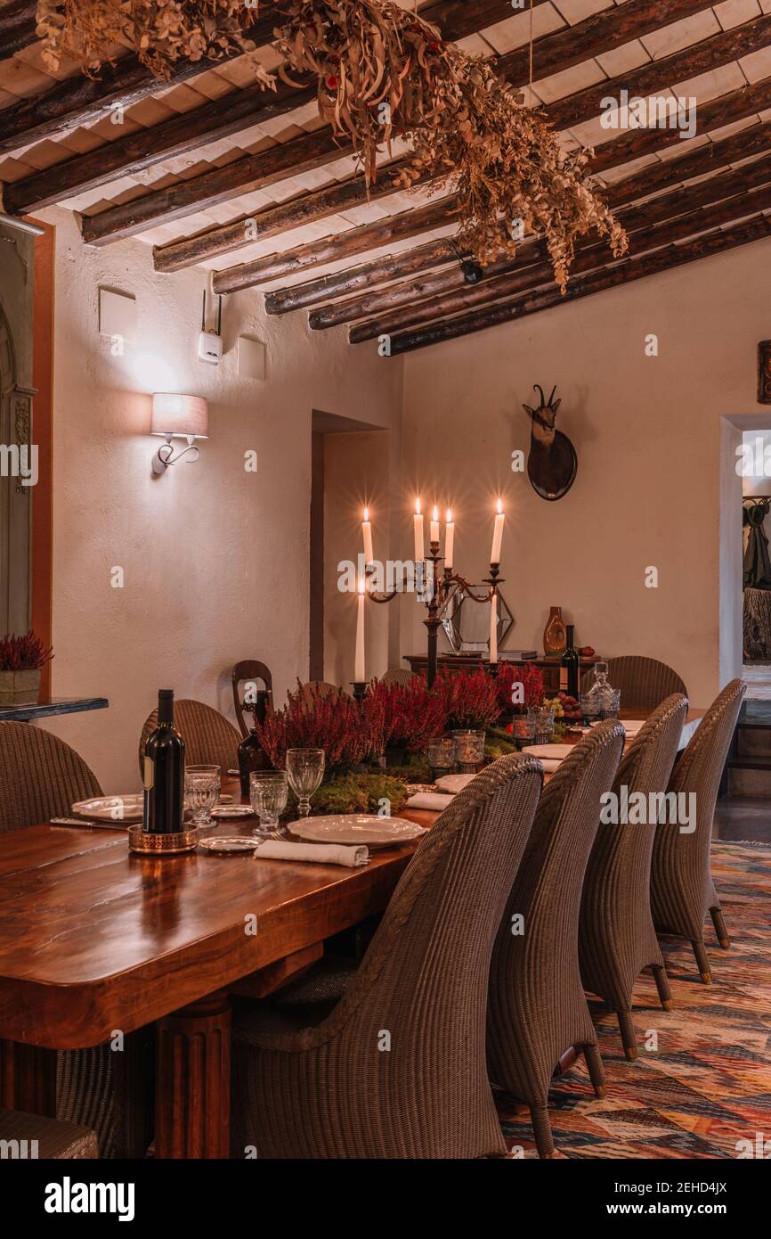 Interior of dining room with wooden table with cutlery and plates ...