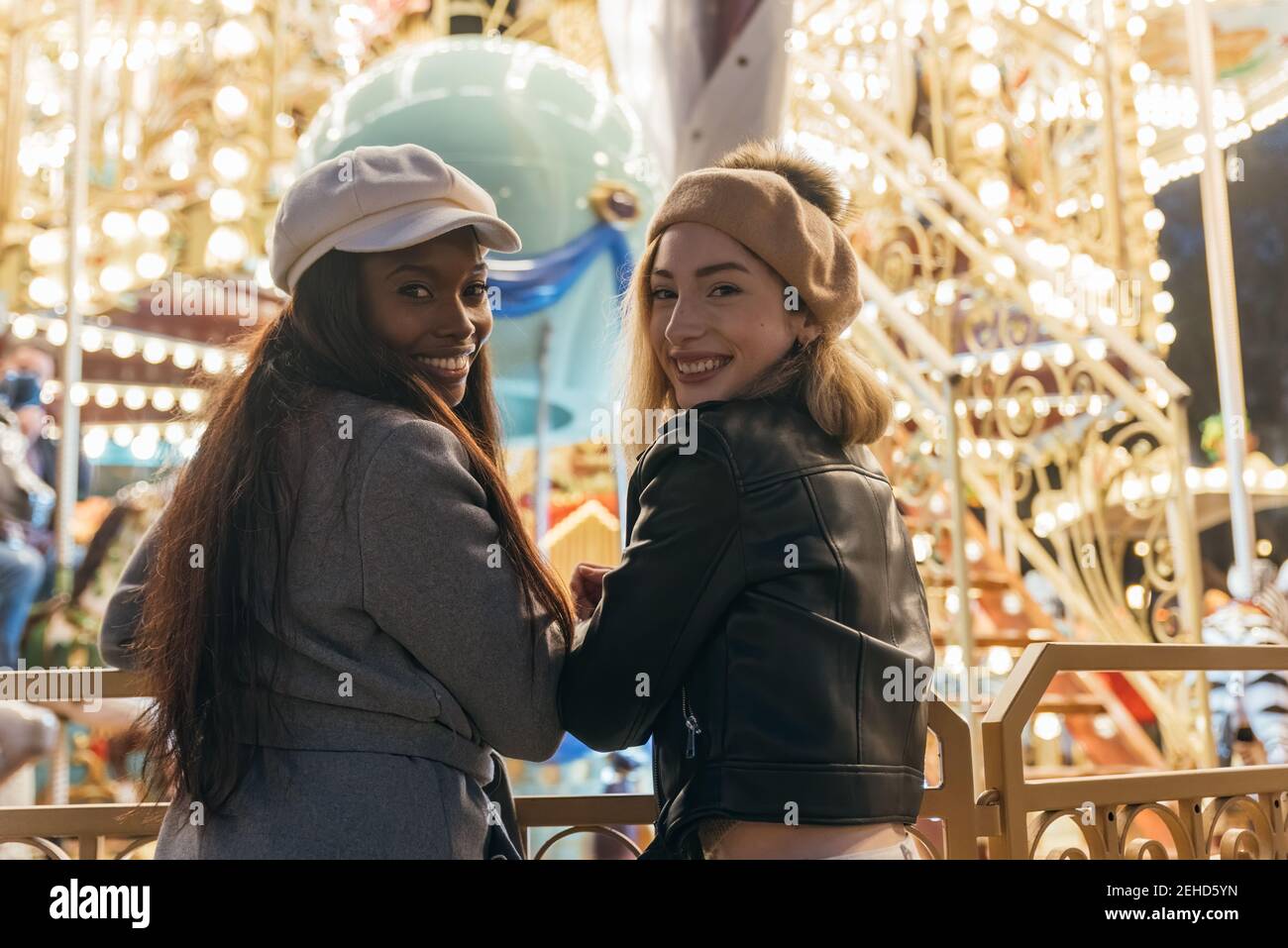 Back view of delighted multiracial female best friends standing near ...