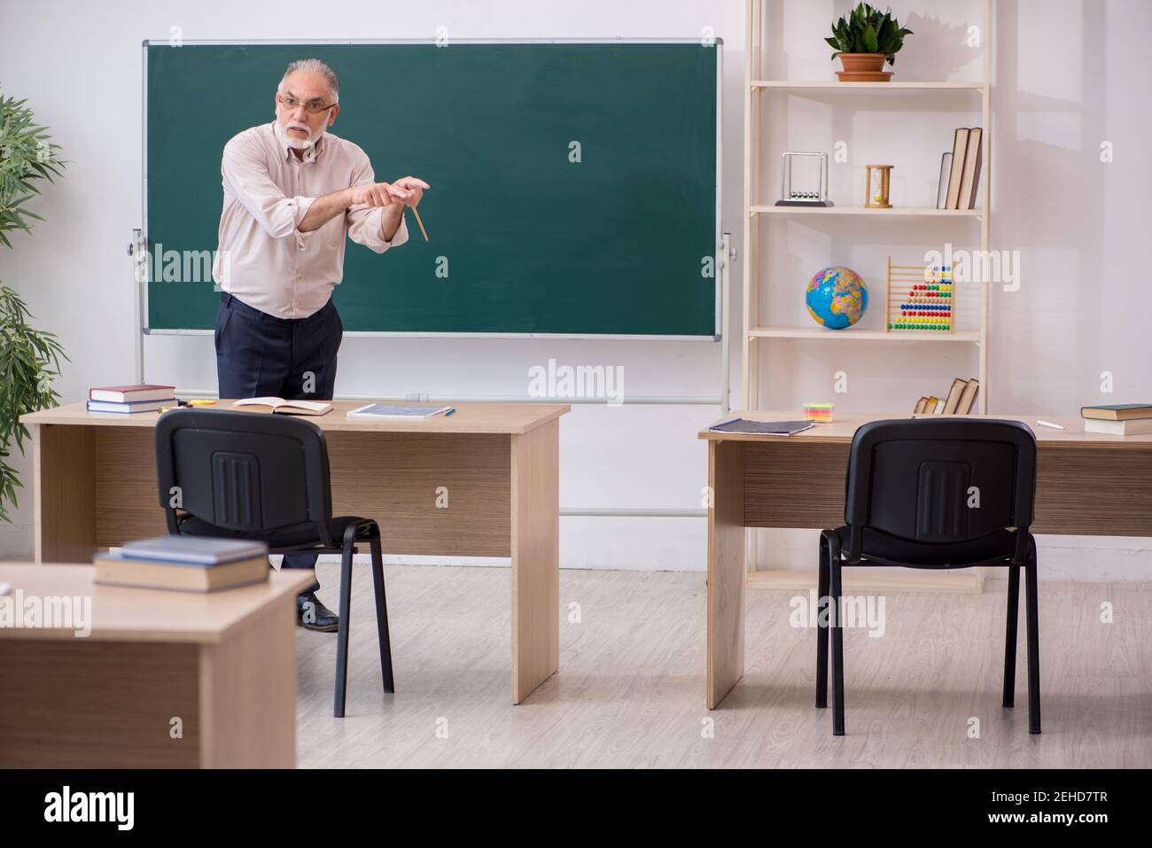 Old teacher in front of blackboard Stock Photo - Alamy