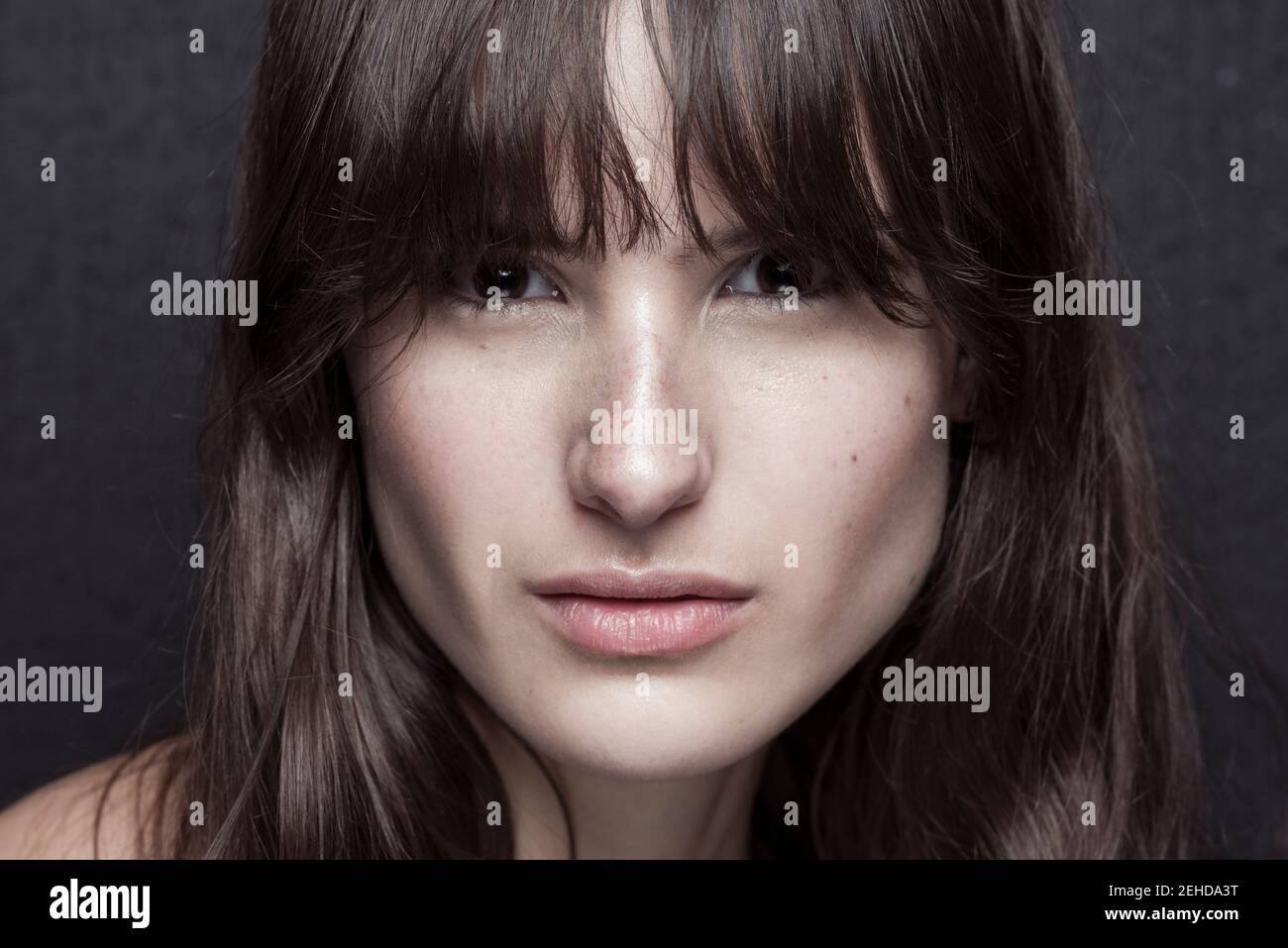 Serious female with makeup and freckles on nose Stock Photo - Alamy