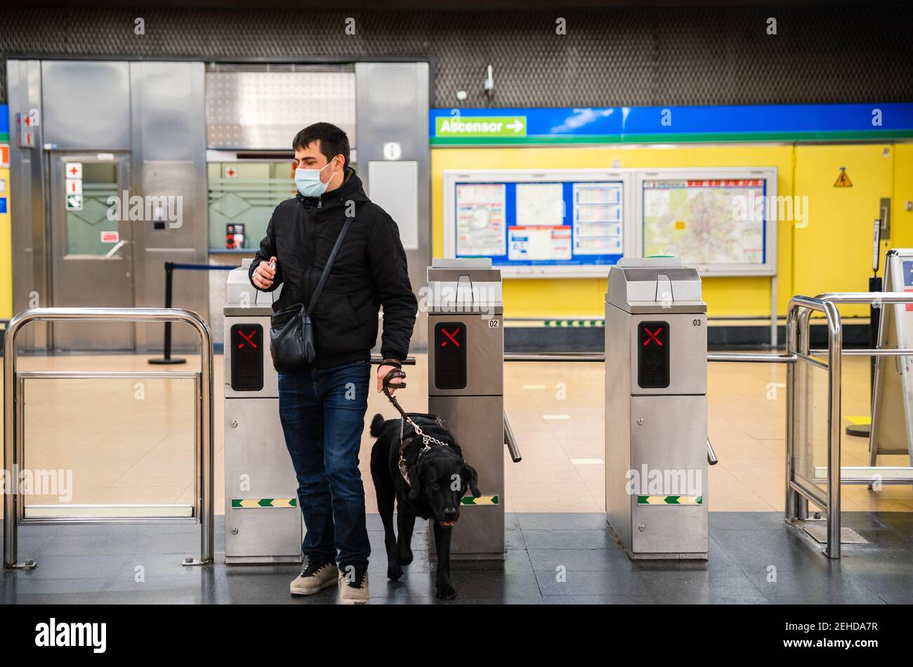 Full body of male in medical mask walking through automatic card reader ...