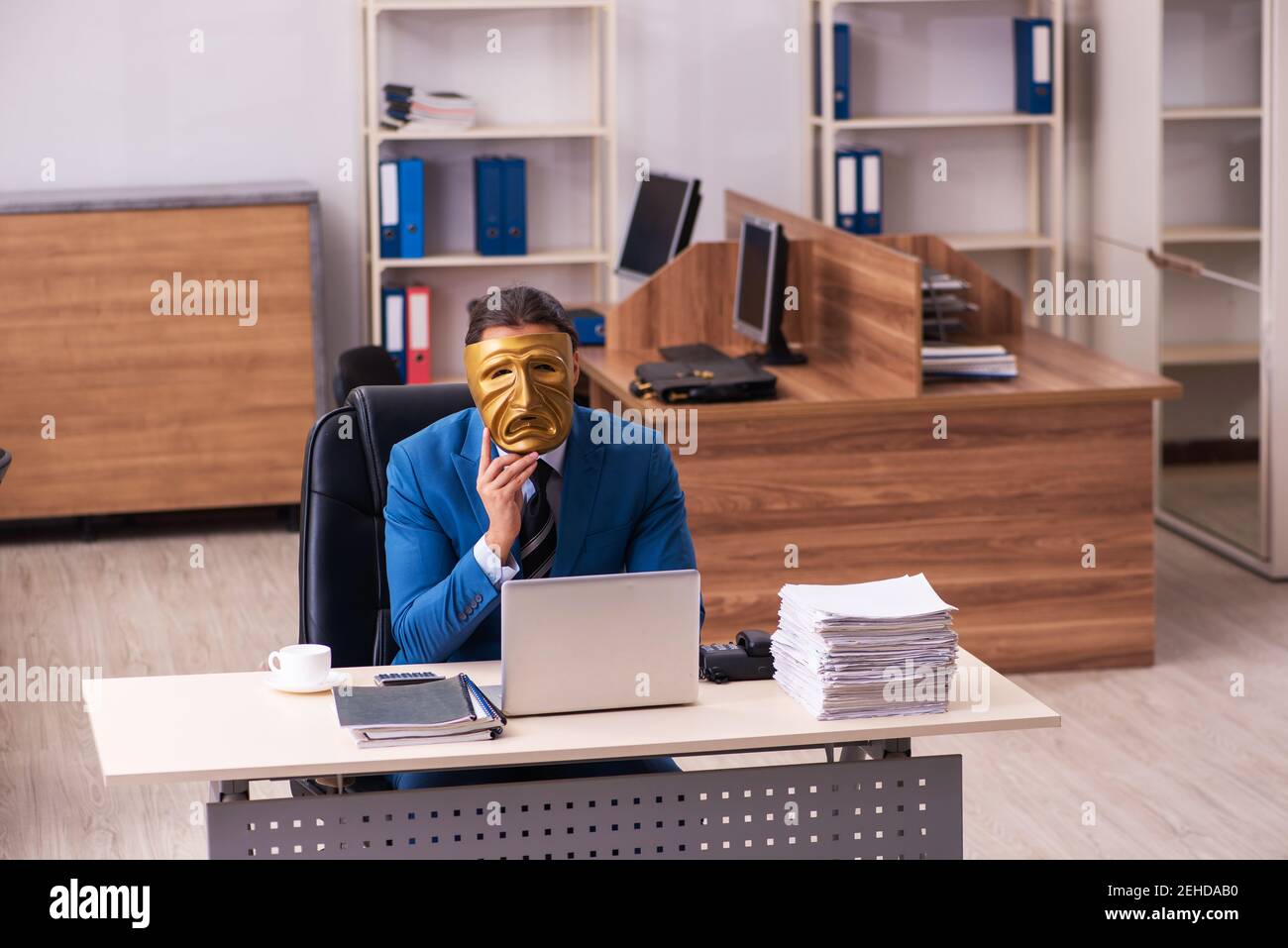 Young employee wearing sad mask in the office Stock Photo - Alamy