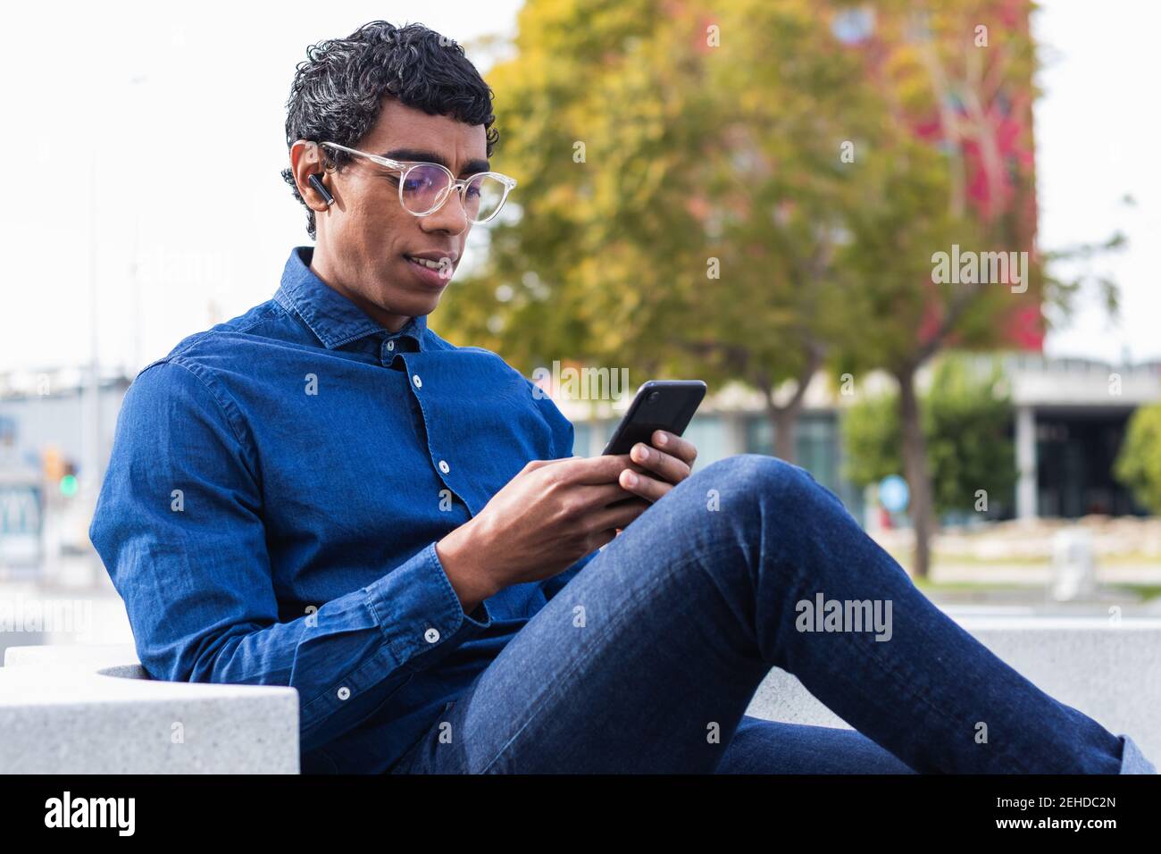 Adult interested ethnic male entrepreneur in stylish clothes text ...