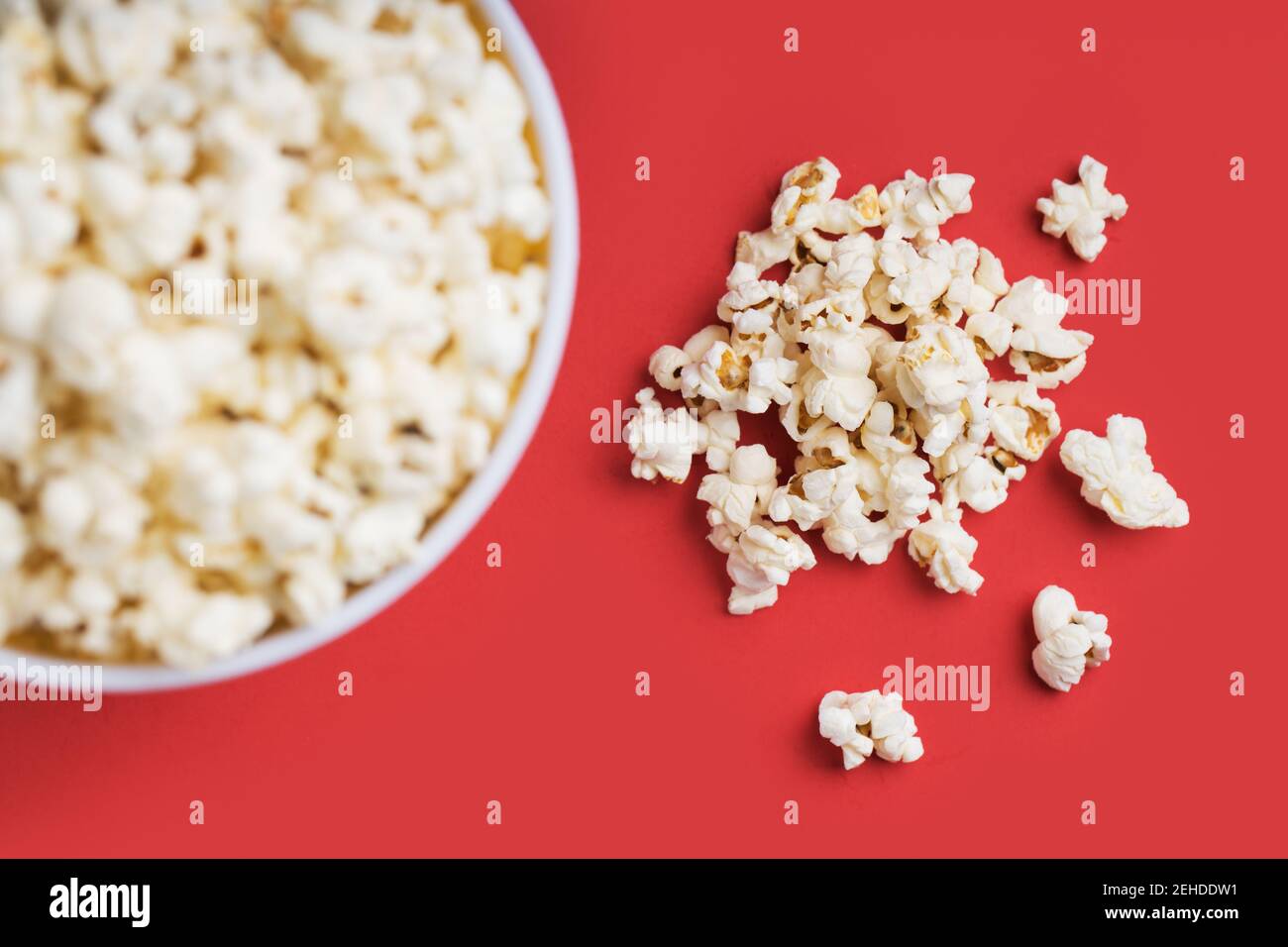 Top view bowl full of popcorn on a red background Stock Photo - Alamy