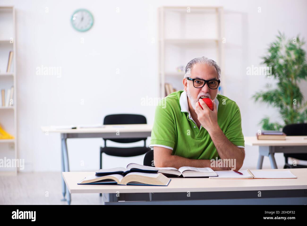 Male teacher eating apple hi-res stock photography and images - Alamy