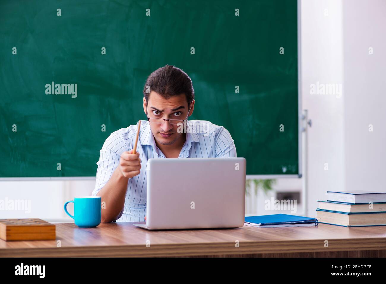 Young teacher in tele-education concept in the classroom Stock Photo ...