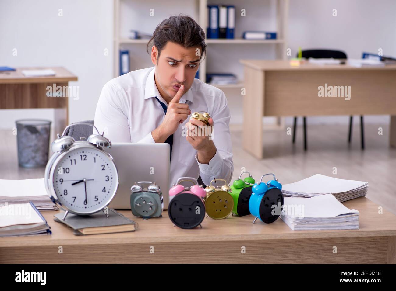 Young employee afraid of missing deadline at workplace Stock Photo - Alamy