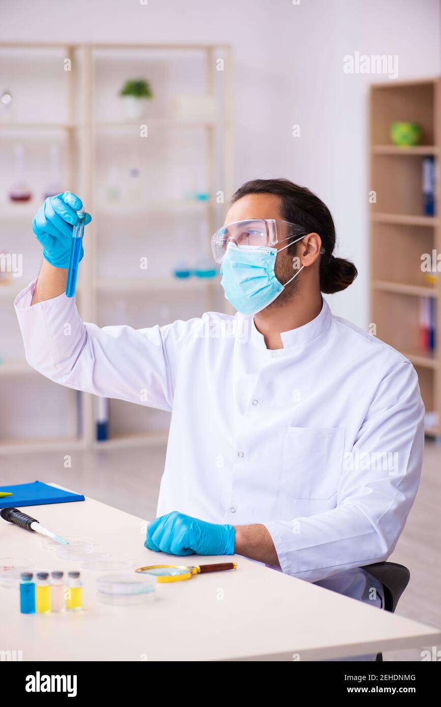 Young chemist working in the lab Stock Photo - Alamy