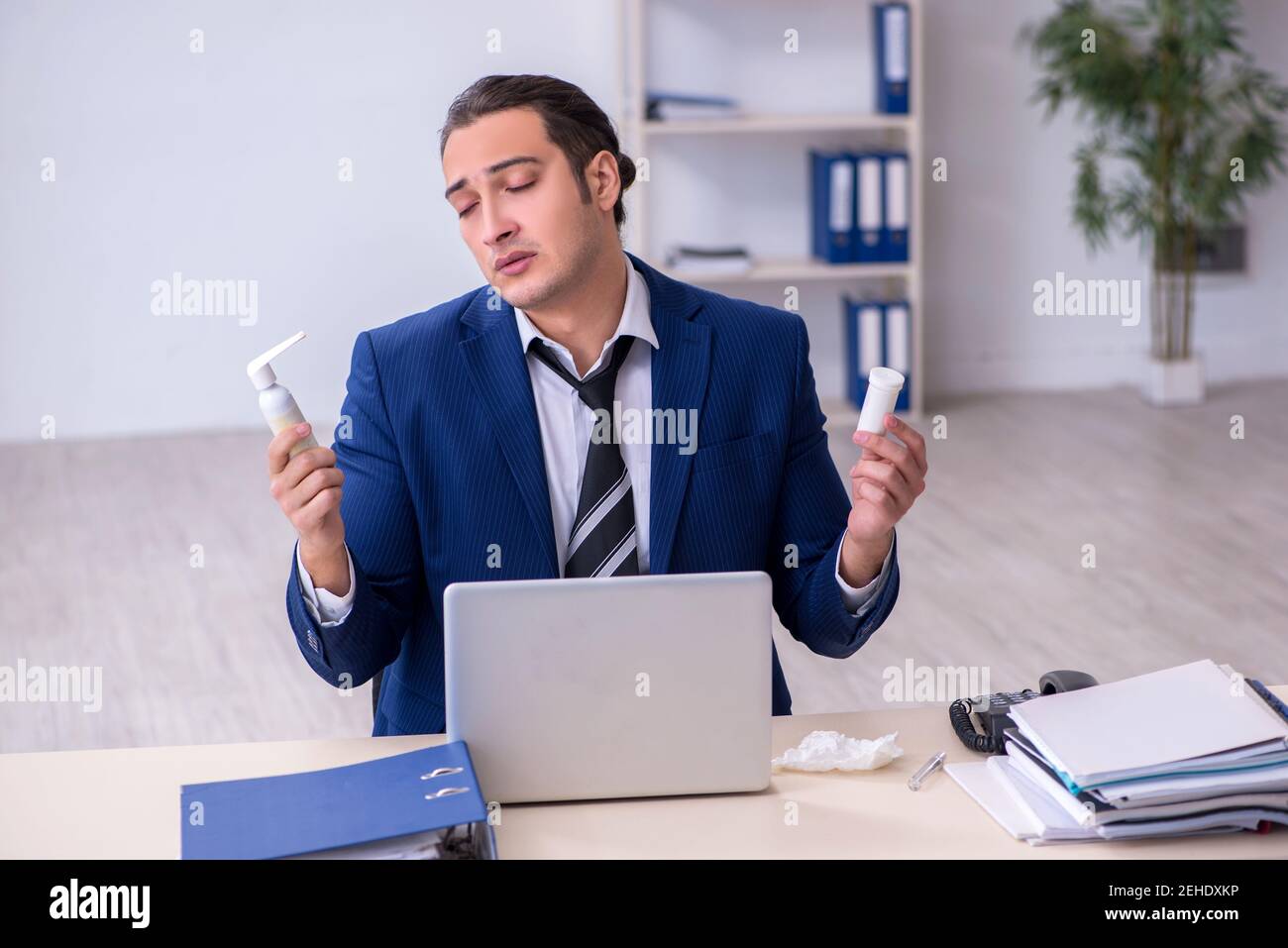 Male employee suffering at workplace Stock Photo - Alamy
