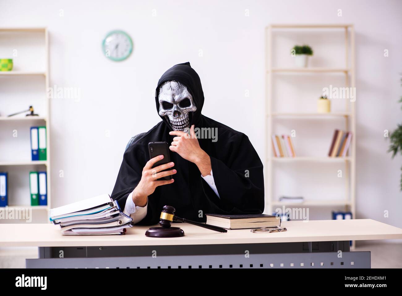 Devil judge working in the courthouse Stock Photo - Alamy