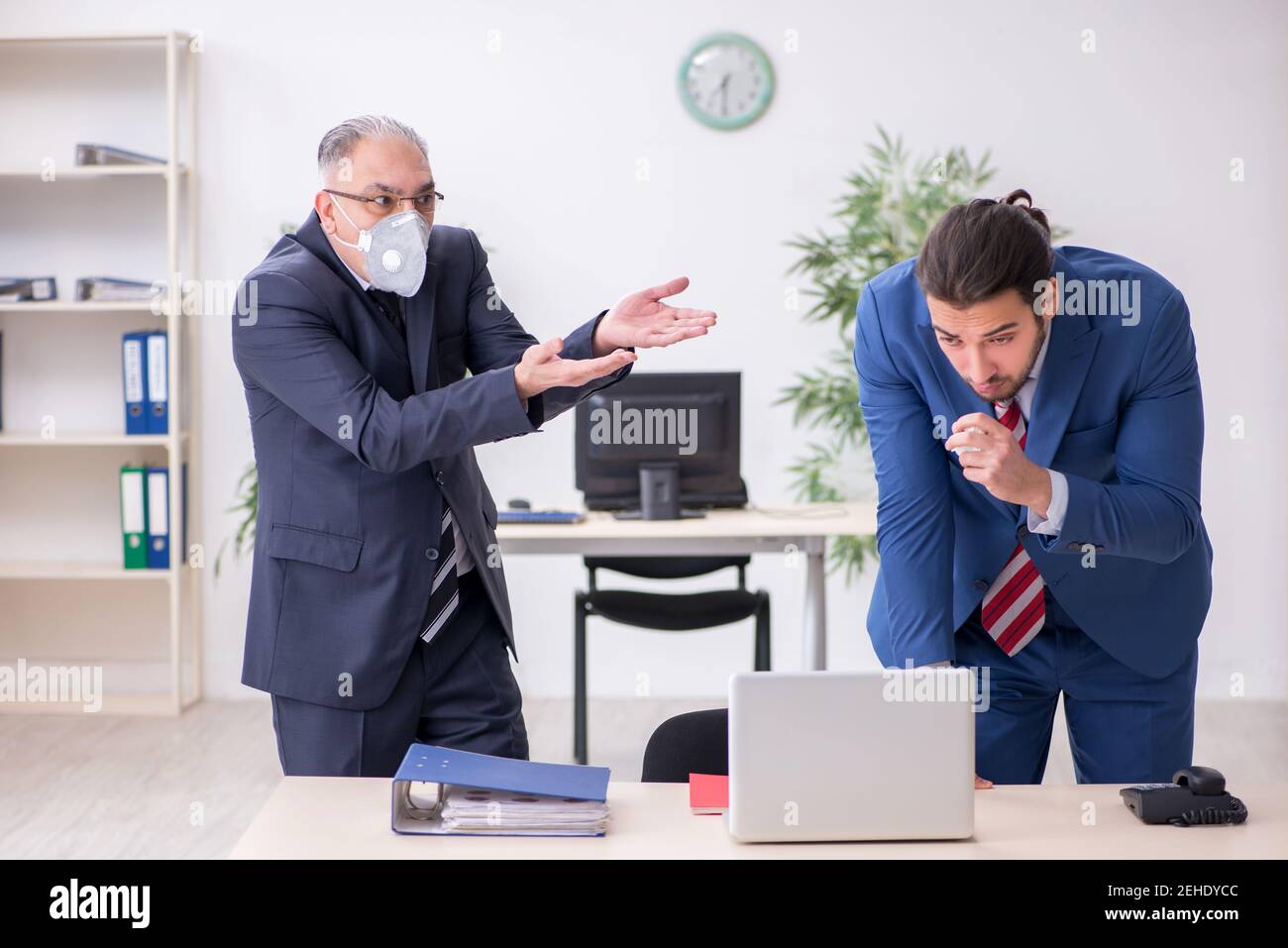 Employees at workplace during pandemic Stock Photo - Alamy