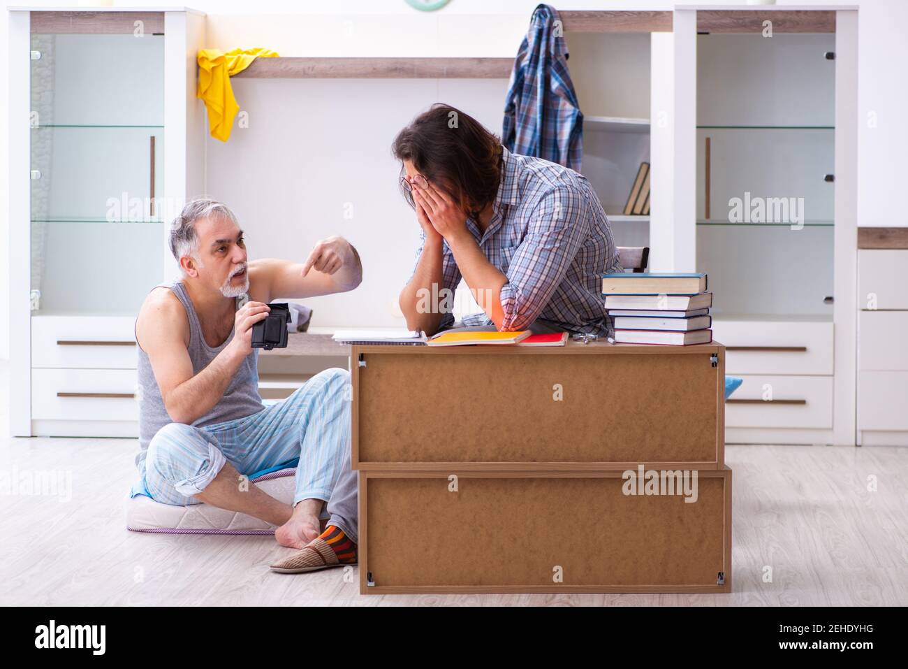Young son student and dad alcoholic at home Stock Photo - Alamy
