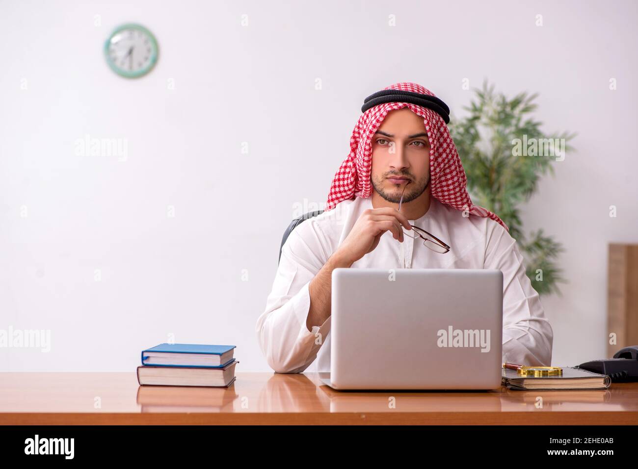 Male arab employee working in the office Stock Photo - Alamy